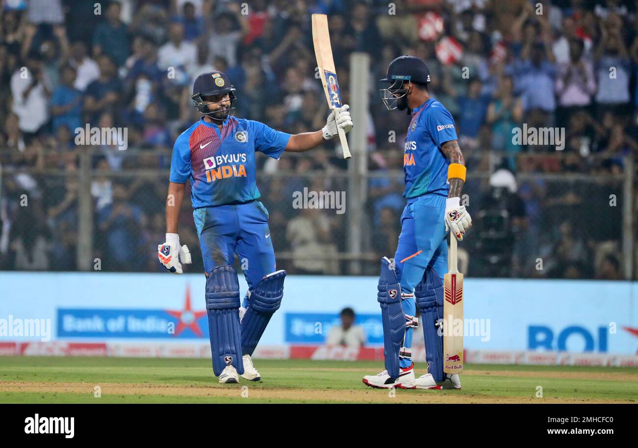India's Rohit Sharma, left, raises his bat after scoring 50 runs as ... India's Rohit Sharma, left, raises his bat after scoring 50 runs as ...