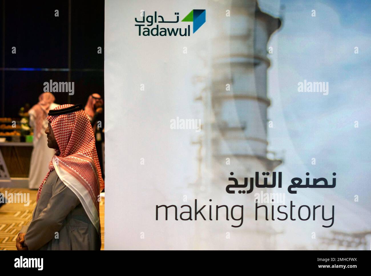 Saudi Arabia's state-owned oil company Aramco employee stands in front ...