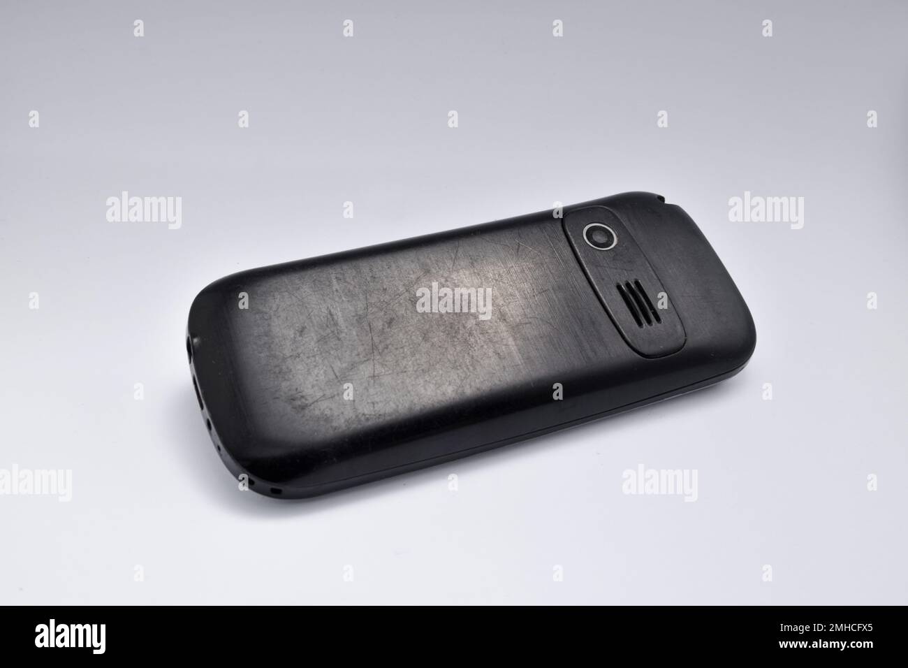 Back of old cell phone with camera on white background Stock Photo - Alamy