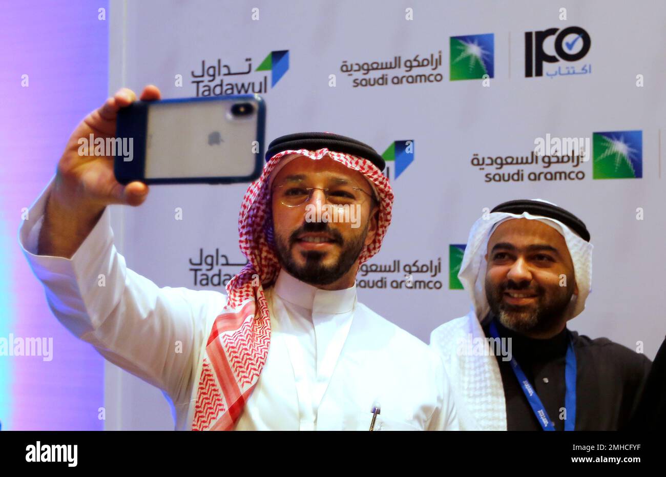 Saudi Arabia's state-owned oil company Aramco employees pose for a ...