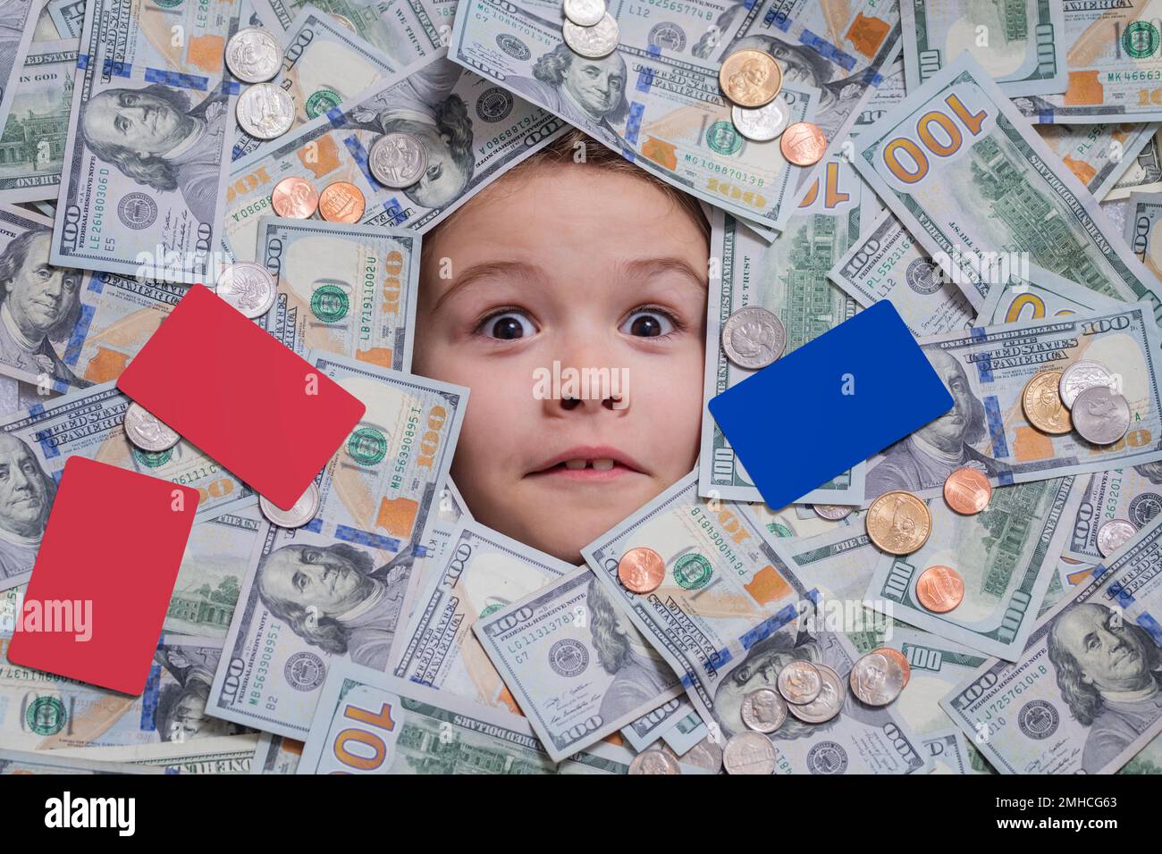 Funny child with fun face with money. Kid peeking out of dollar bills ...