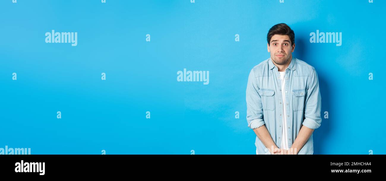 Embarrassed guy want to pee, waiting in line for toilet, standing ...