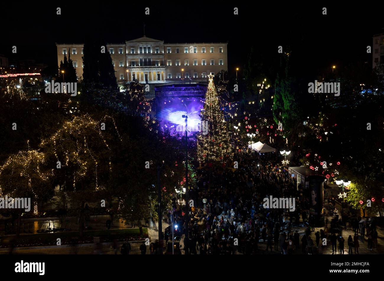 People walk next newly illuminated Christmas tree at central Syntagma ...