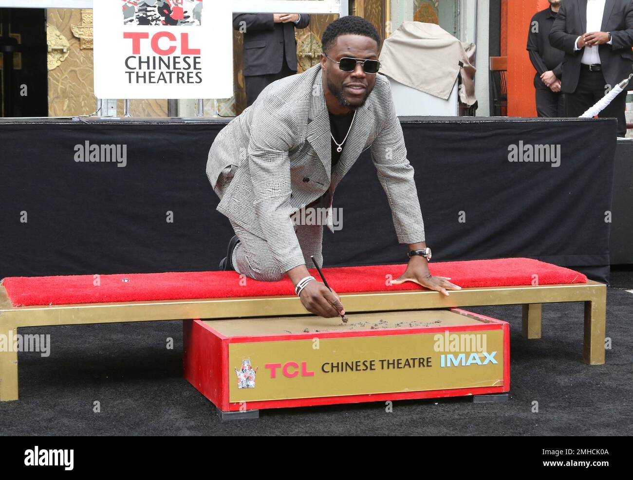 Kevin Hart signs his name in cement during a hand and footprint ...