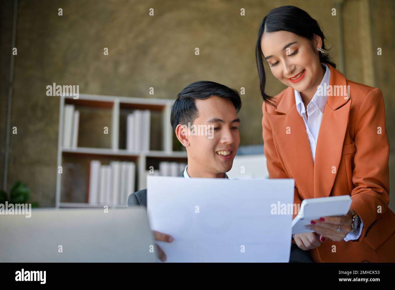 Smart and professional millennial Asian male CEO working with his ...