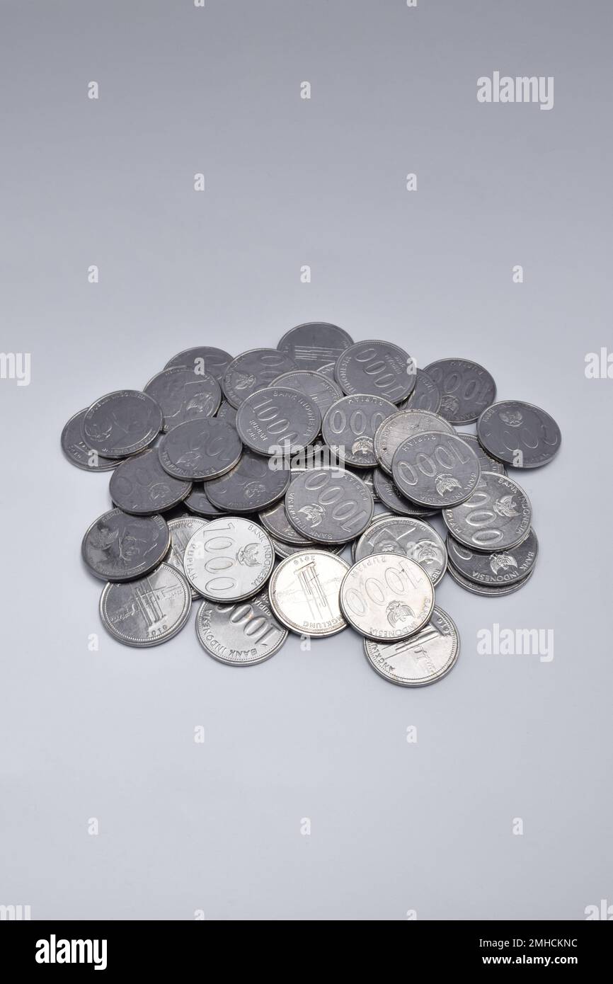 Pile of Indonesian thousand rupiah coins isolated on a white background ...