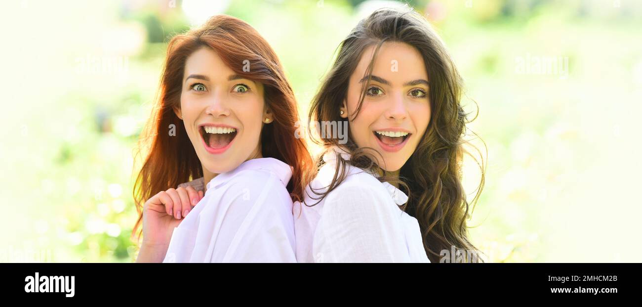 Sensual woman spring outdoor portrait banner. Two excited women friends ...