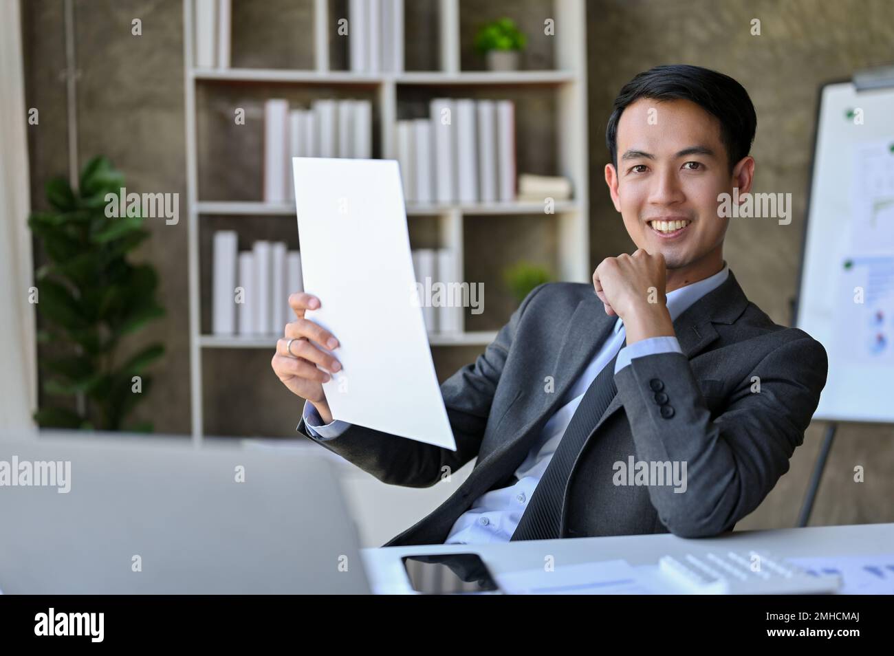 Smart and successful millennial Asian businessman or male CEO in formal ...