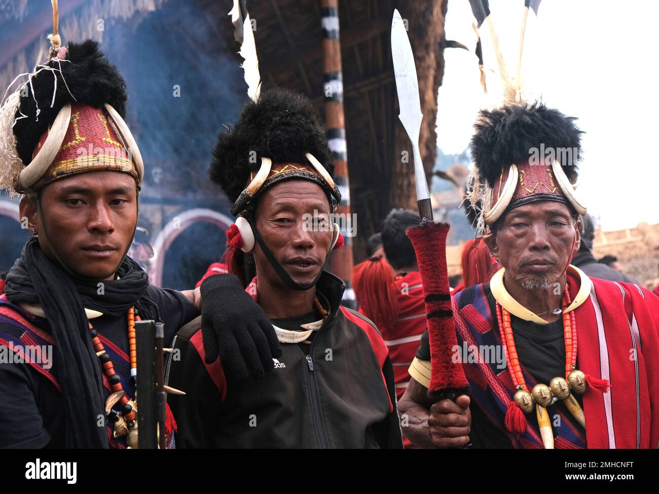 Naga stand dressed in traditional finery during the Hornbill festival ...