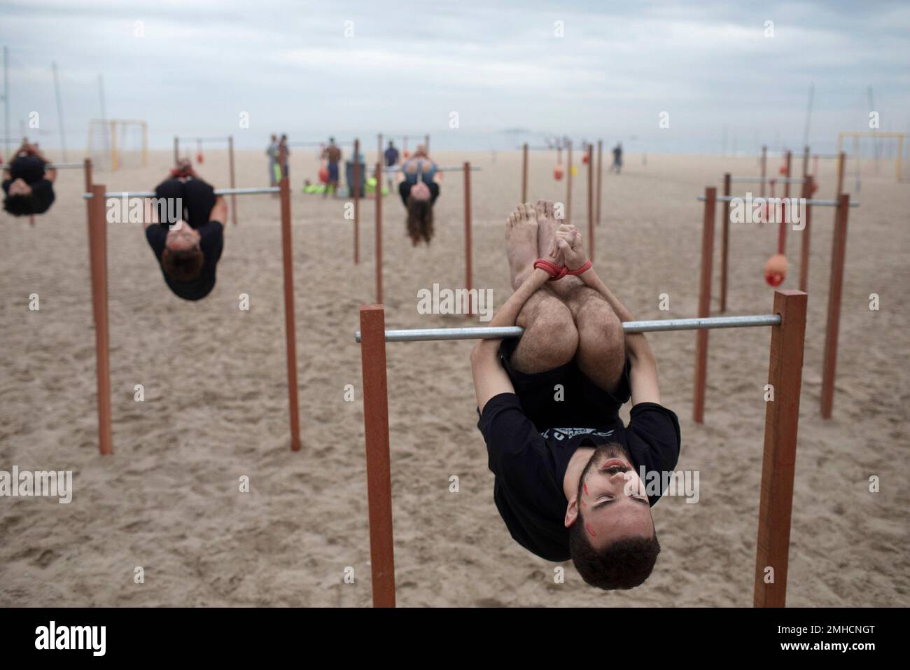 Activists perform as victims tied to a torture device, called parrot's ...