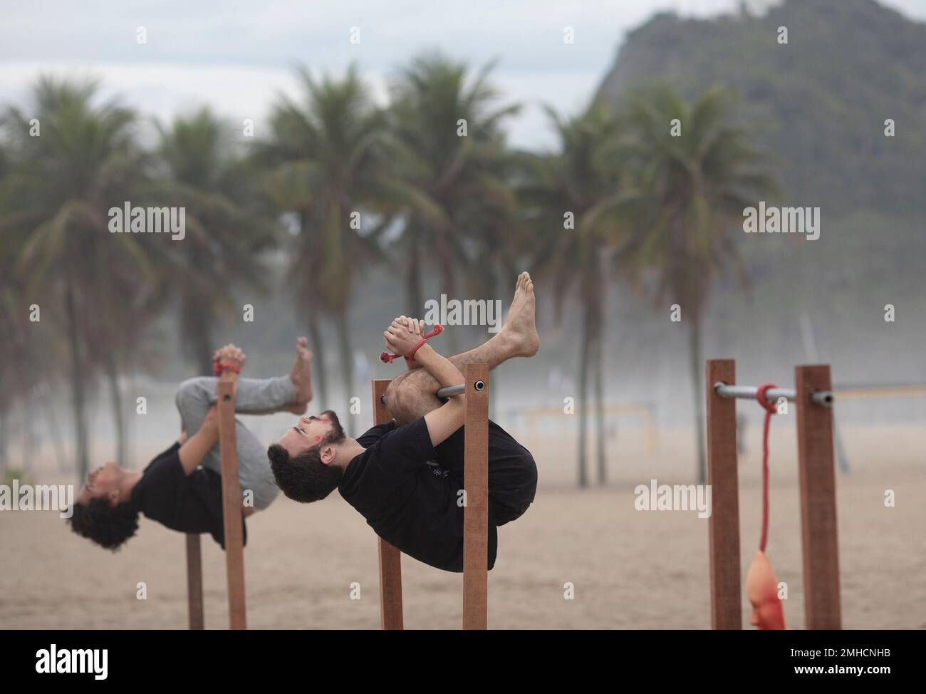 Demonstrators perform as victims in a torture device, called pau-de ...