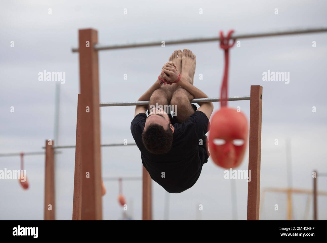A demonstrator performs as a victim in a torture device, called pau-de ...