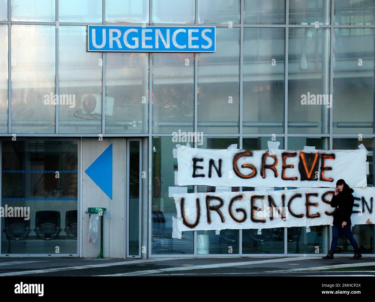 A person walks past a banner that reads: "Emergency Strike" in the ...