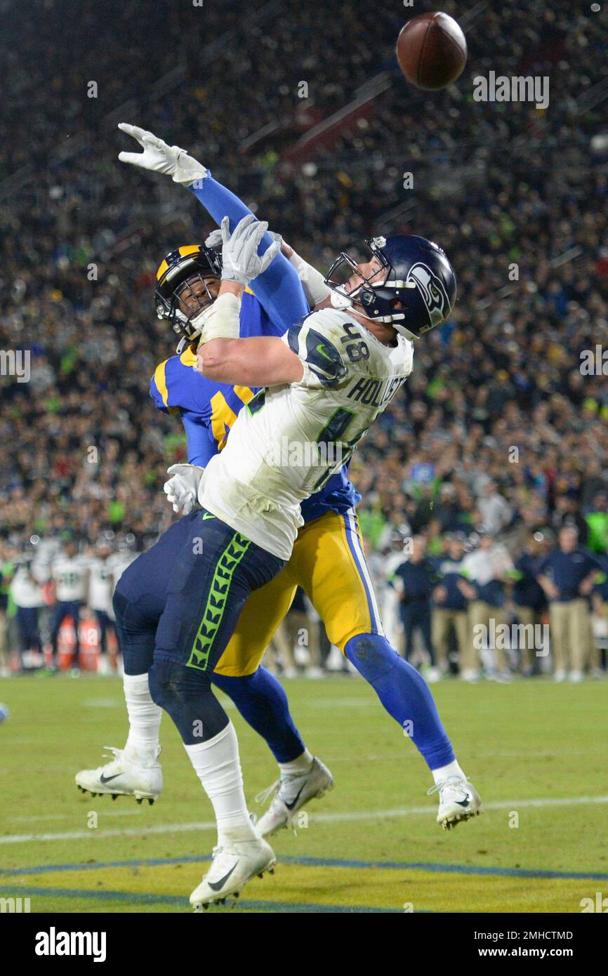 Los Angeles Rams linebacker Travin Howard, back, interrupts a pass ...