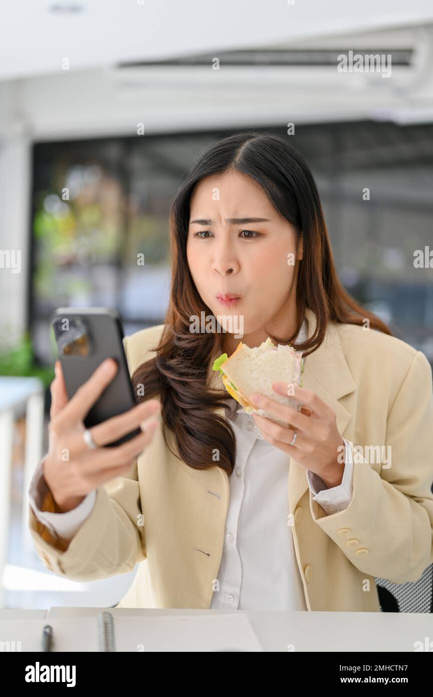 Busy asian woman having snack hi-res stock photography and images - Alamy