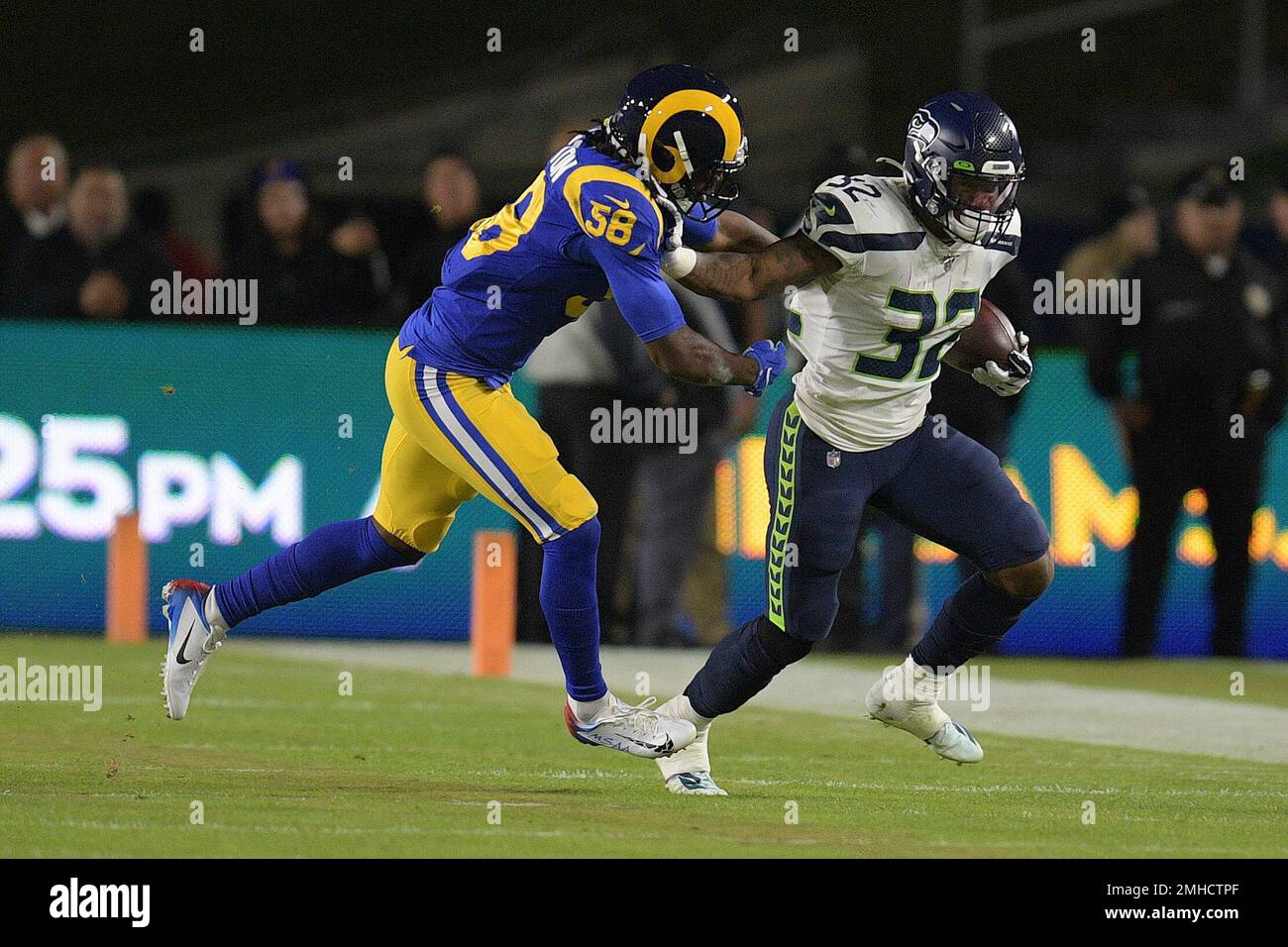 Seattle Seahawks running back Chris Carson, right, sprints with the bal ...