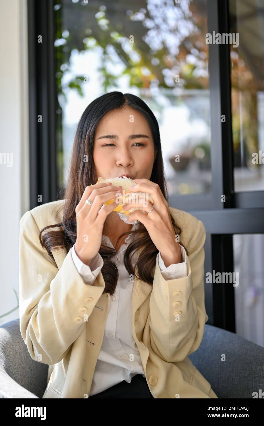 Portrait, Happy and hungry millennial Asian businesswoman or female ...
