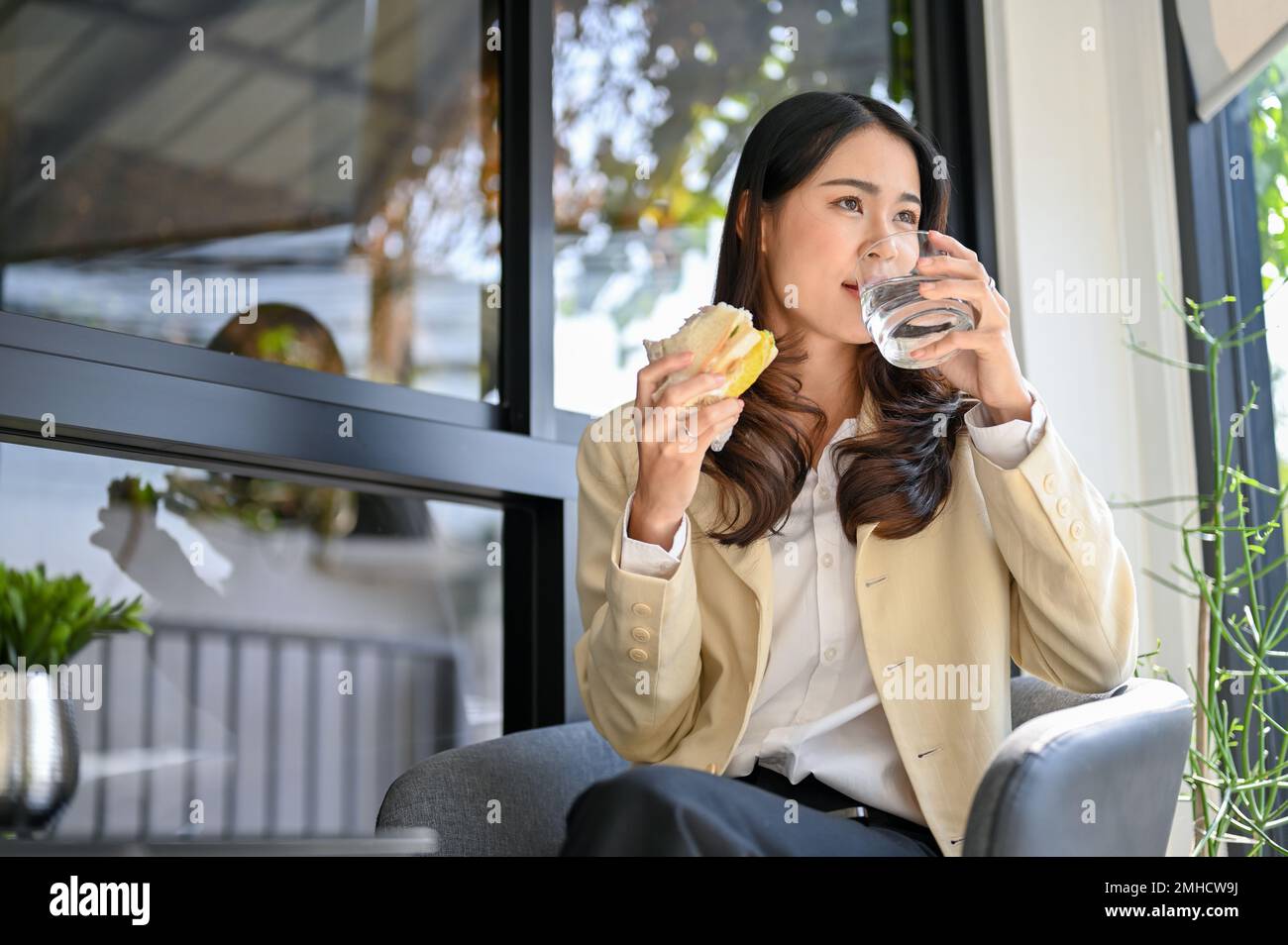 Elegant and successful millennial Asian businesswoman having an easy ...