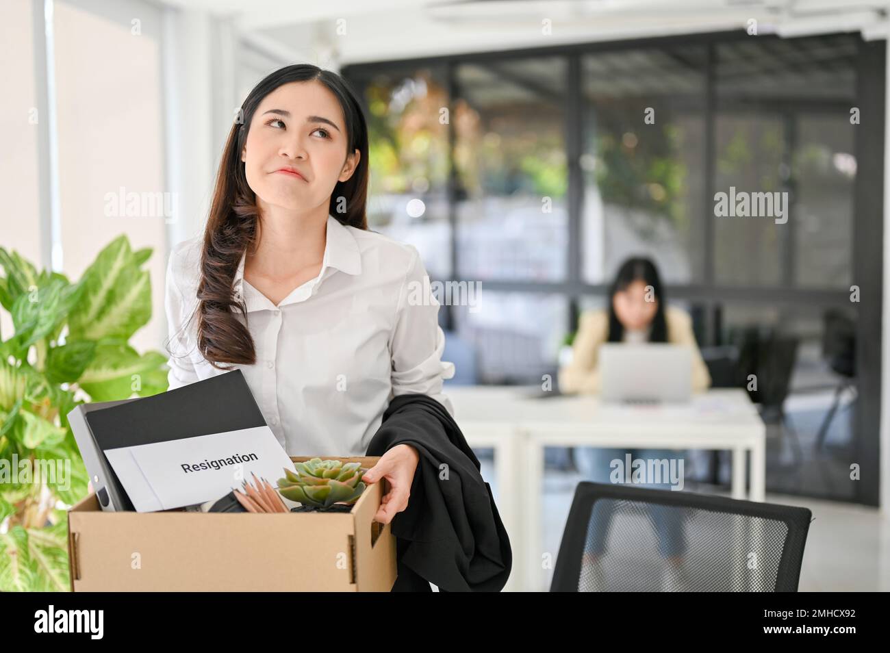 Happy and fearless Asian woman carrying her personal stuff and ...