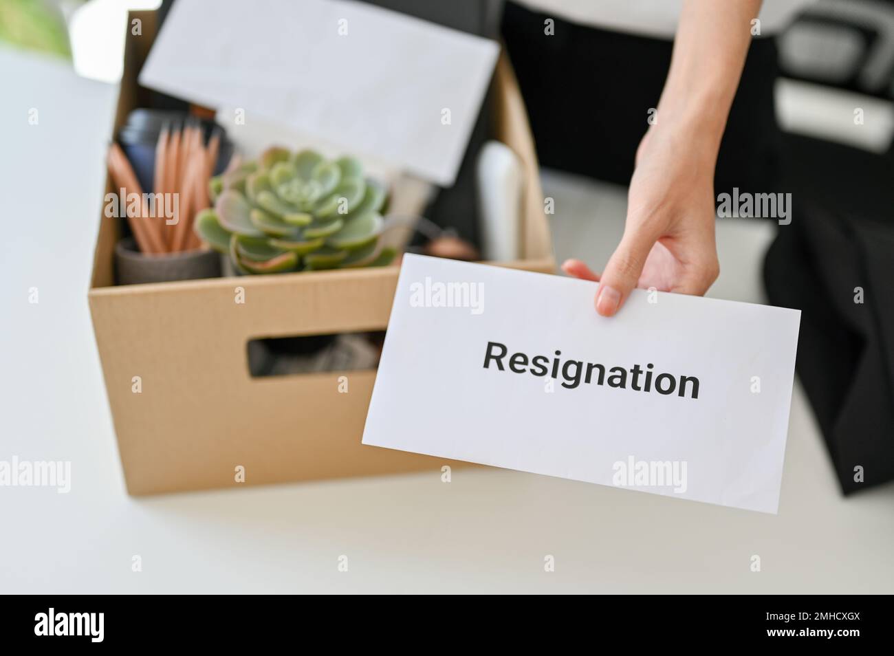 close-up image, A female office worker with a cardboard box on table ...