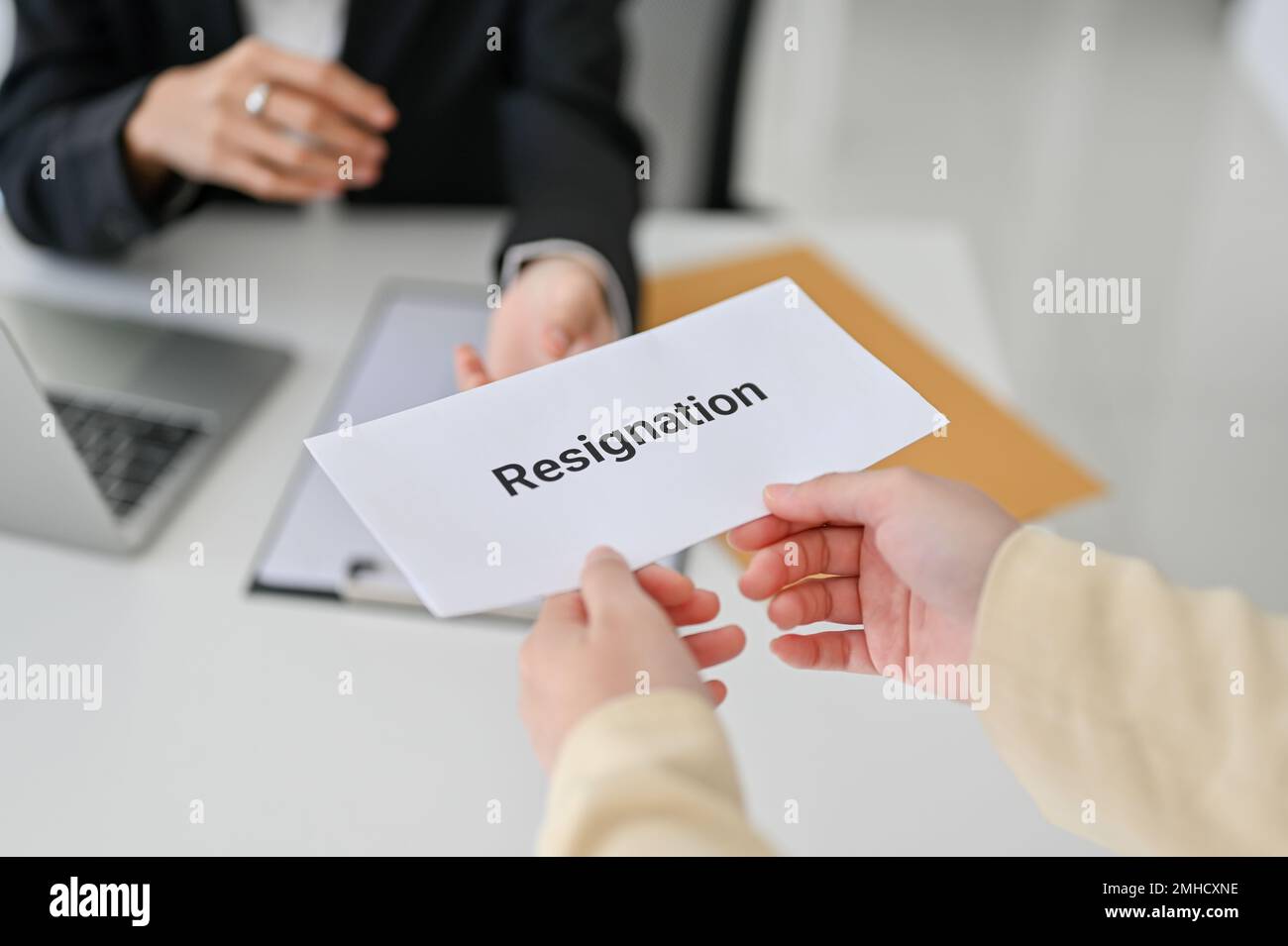 A businesswoman or female office worker handing her resignation latter ...