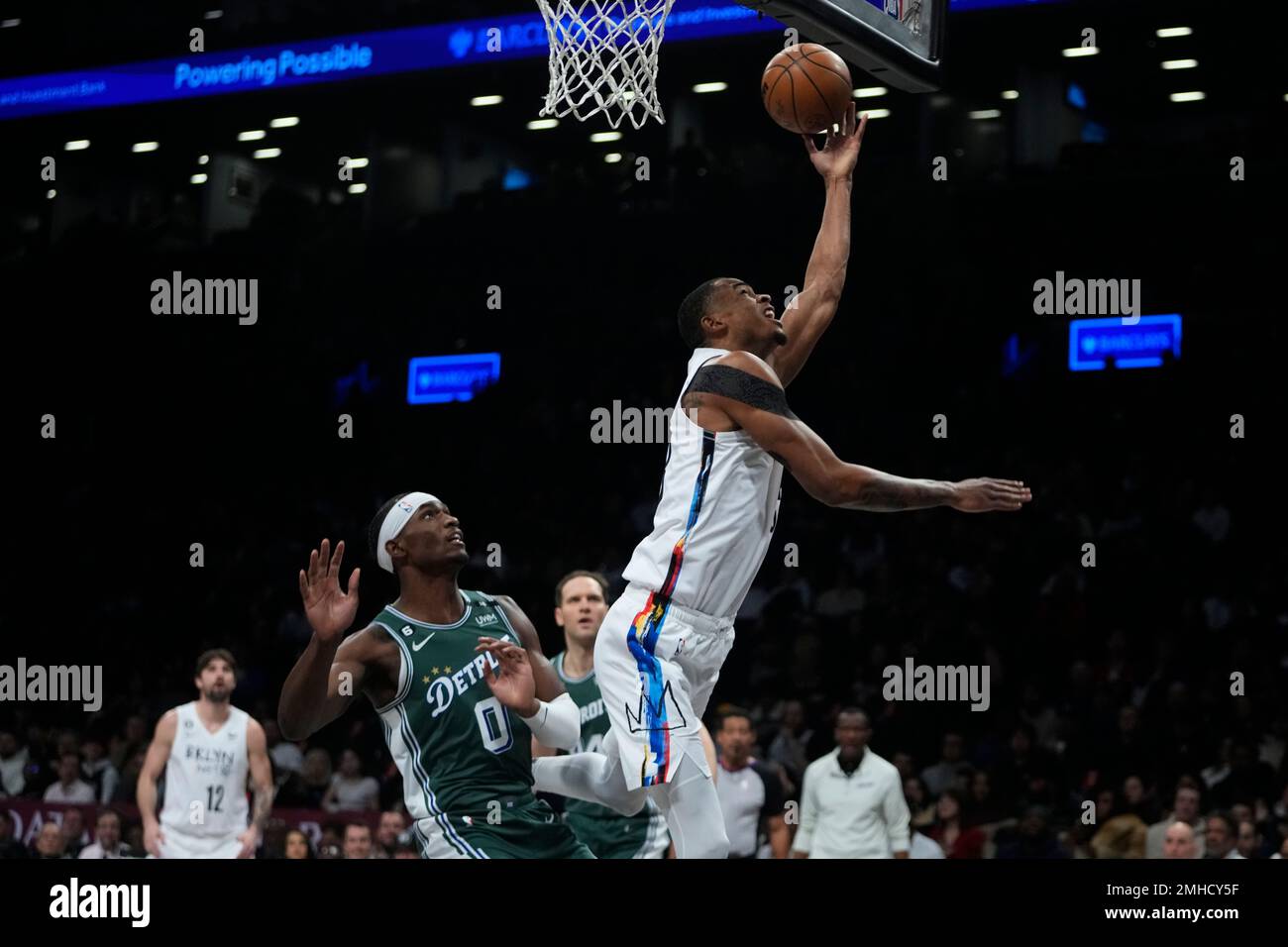 Brooklyn Nets' Nic Claxton, right, drives past Detroit Pistons' Jalen ...