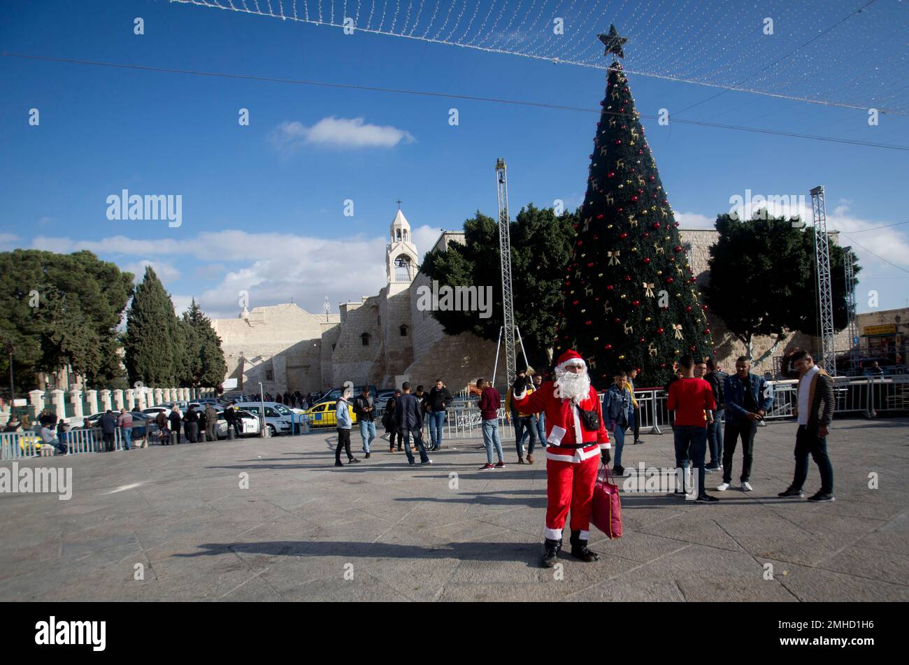 In this Thursday, Dec. 5, 2019, photo, a Palestinian wearing a Santa ...