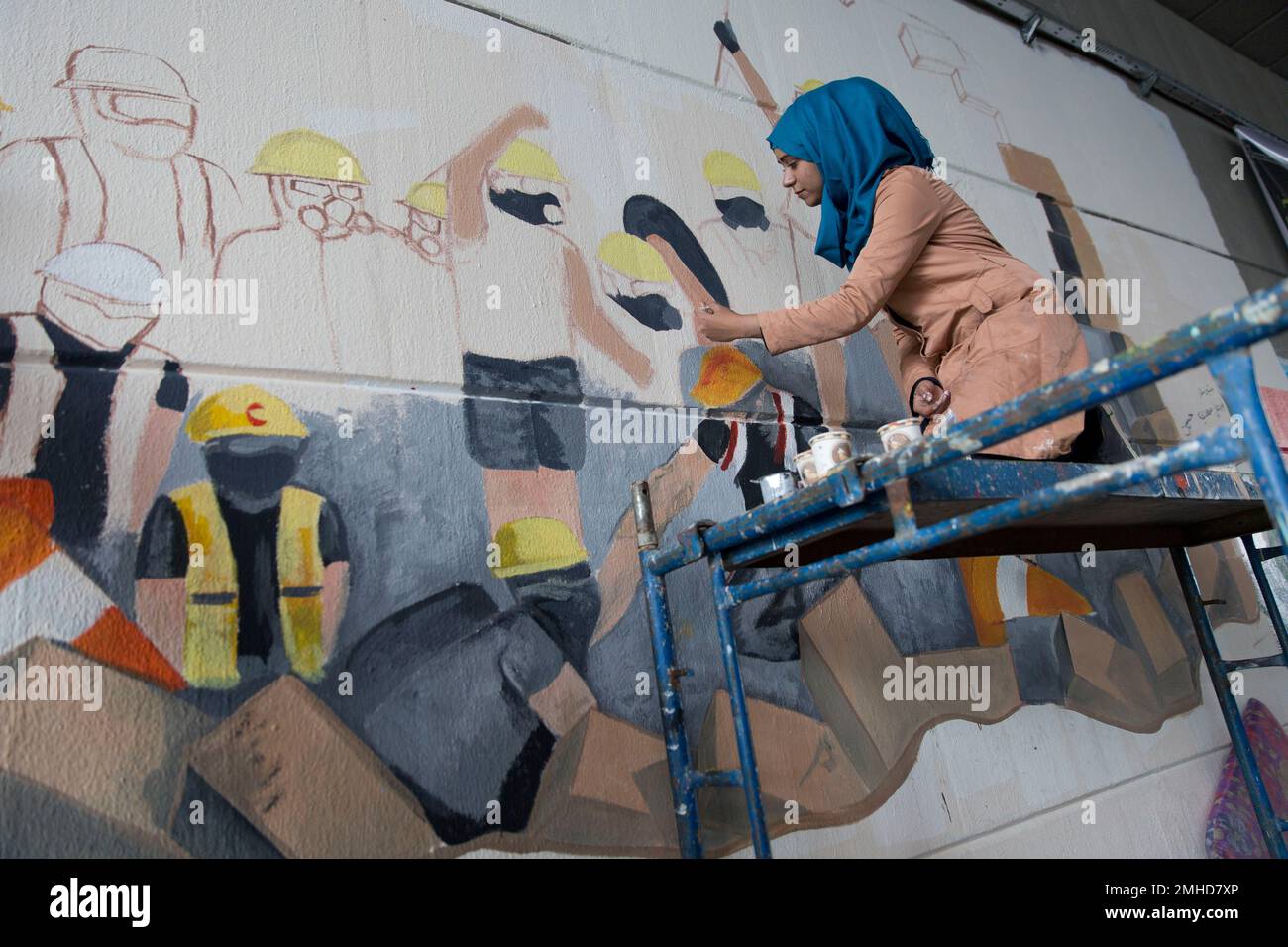 Iraqi street artist Sabah Ala', 18 works on a mural, in Baghdad, Iraq ...