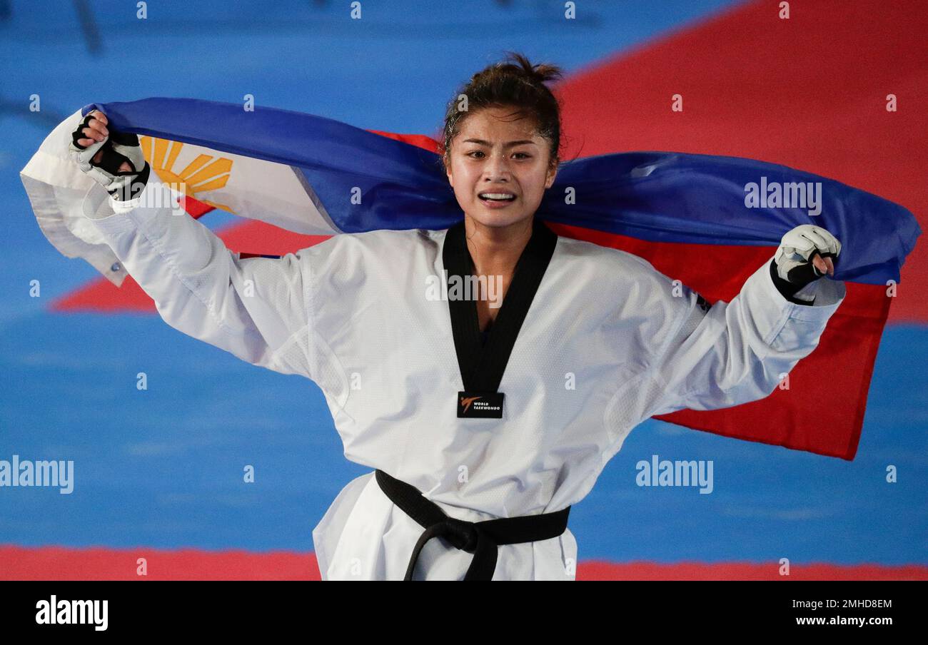 Philippines' Pauline Lopez carries the national flag after winning gold ...