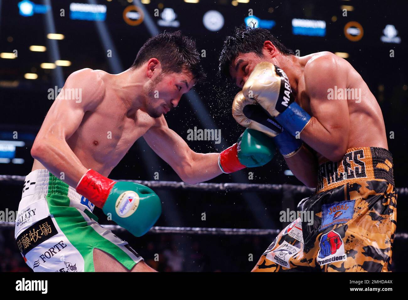 Japan's Ryosuke Iwasa punches Philippines' Marlon Tapales during the ...