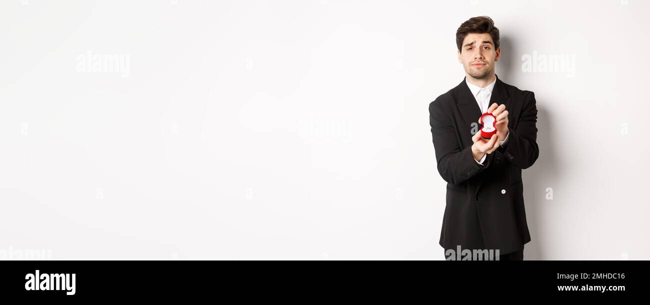 Portrait of handsome man making a proposal, asking to marry him ...