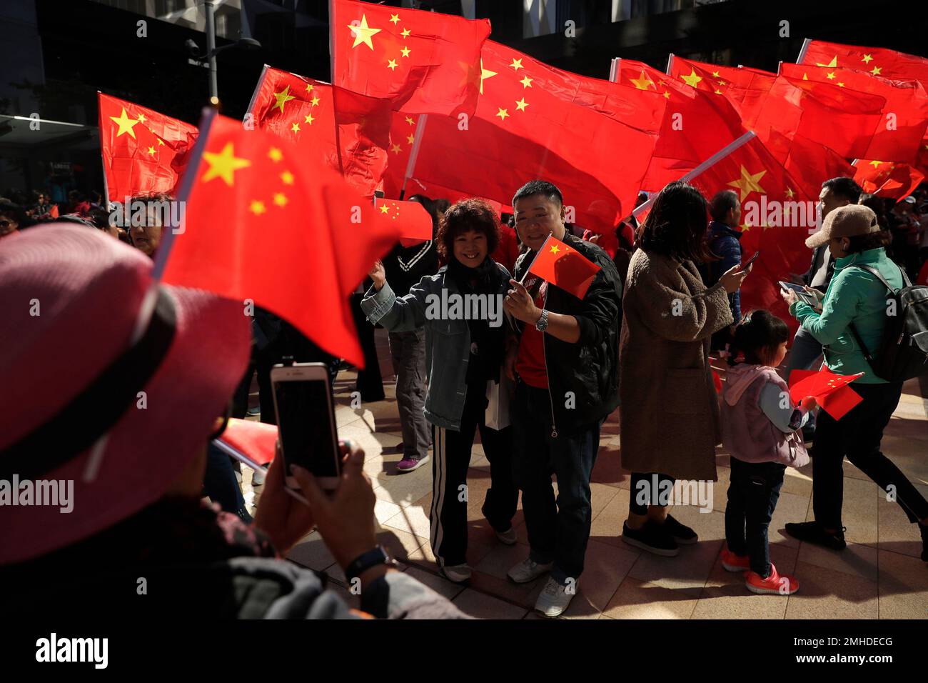 Pro-Beijing supporters wave the Chinese national flags during a rally ...