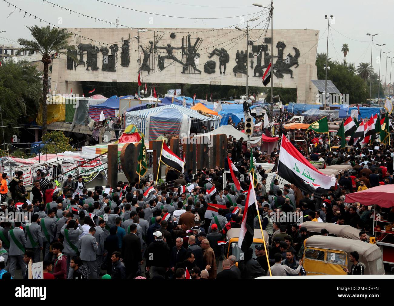 People hold national flags and chanting religious slogans march in ...