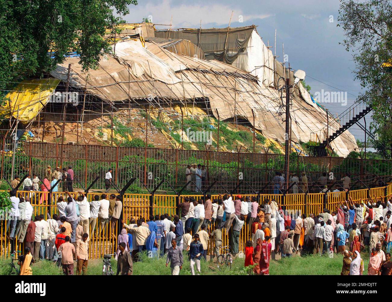 FILE - In this July 5, 2005, file photo, people look through the fence ...