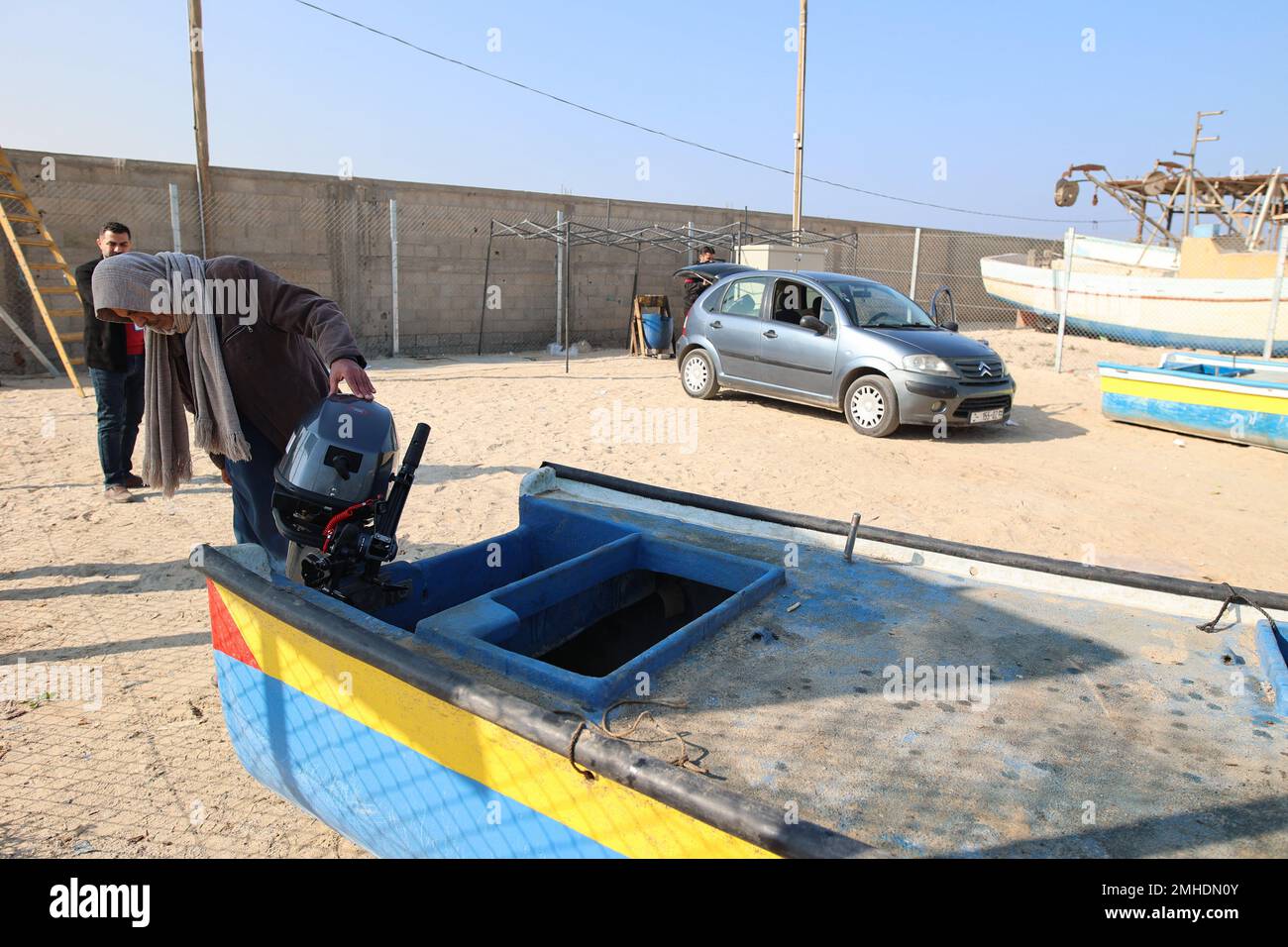 A Palestinian fisherman Zeiad Al-Najar 68, checks his new engine which ...
