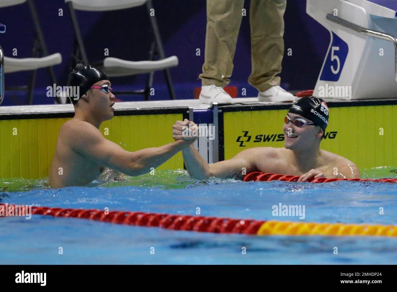Singapore's Joseph Schooling, right, congratulates for team mate Tzen ...