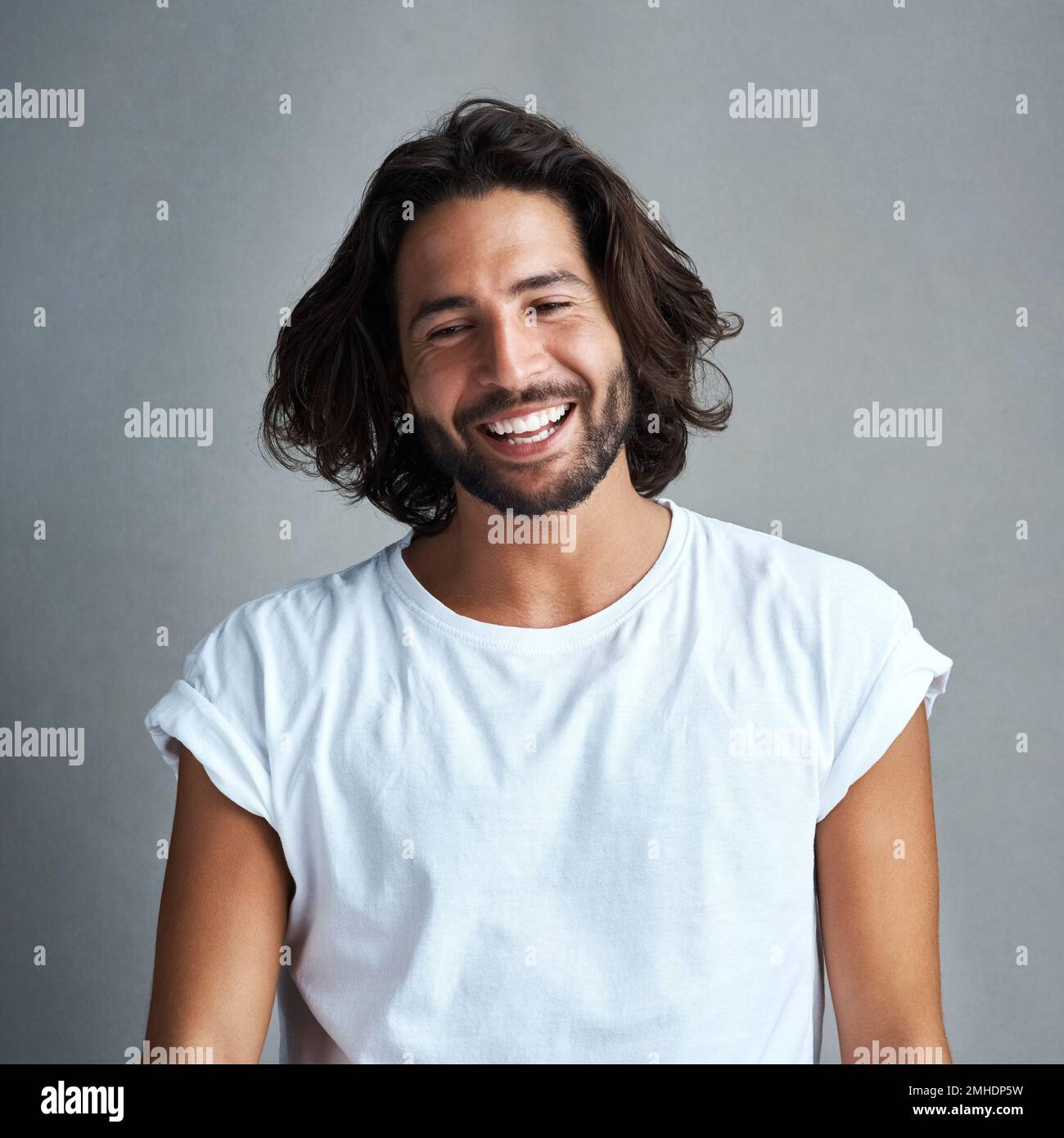 Even more handsome when he smiles. Studio shot of a handsome young man ...