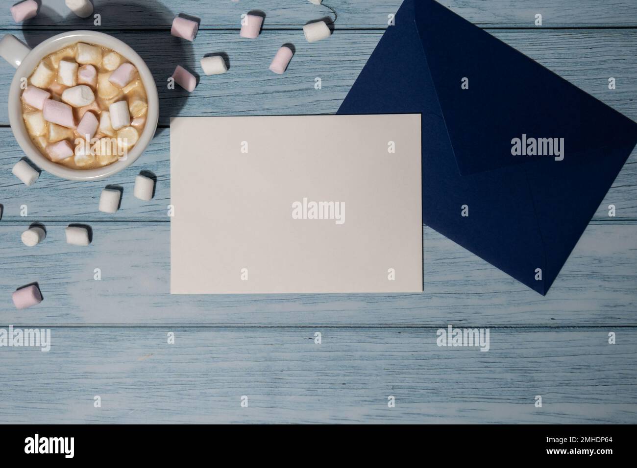 Empty greeting or invitation card mock up blue envelope with white cup ...