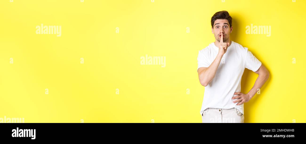 Image of excited guy planning surprise, shushing at camera, press ...