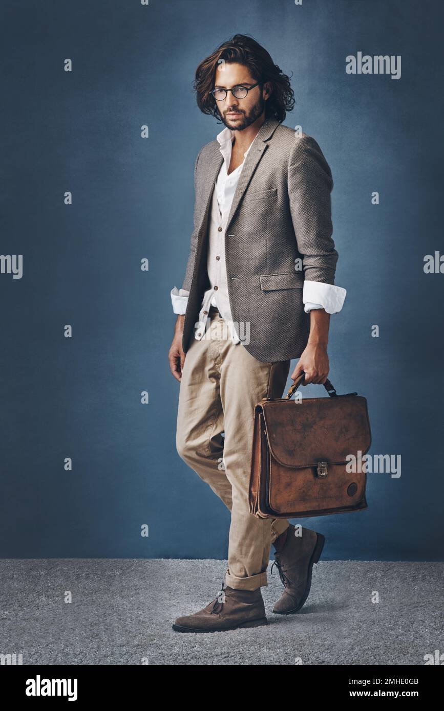 Dashing from head to toe. Studio shot of a handsome young man posing ...