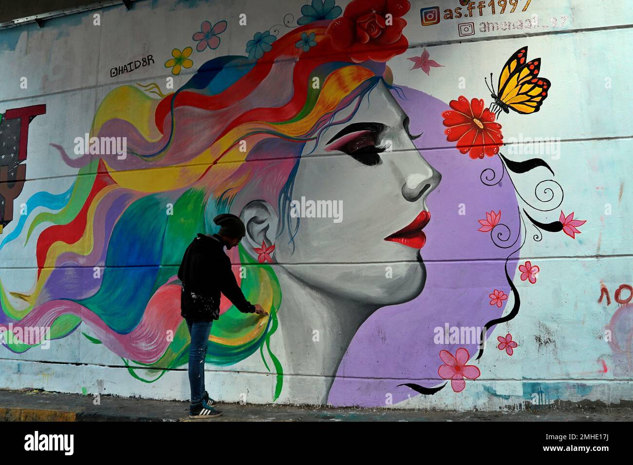 An Iraqi artist draws a graffiti during a sit-in at Tahrir Square in ...