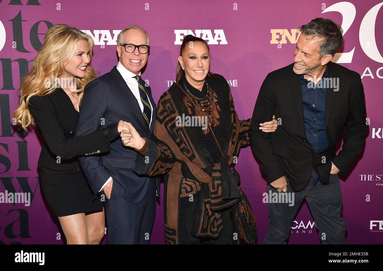 Model Christie Brinkley, from left, poses with designers Tommy Hilfiger ...