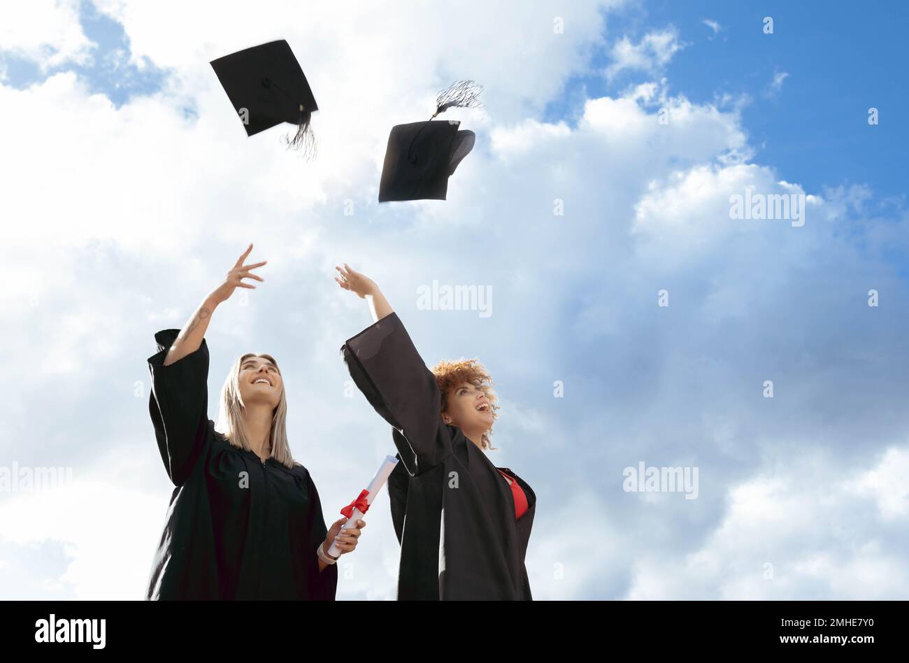 Graduate women, friends and cap in air for celebration, happiness or ...
