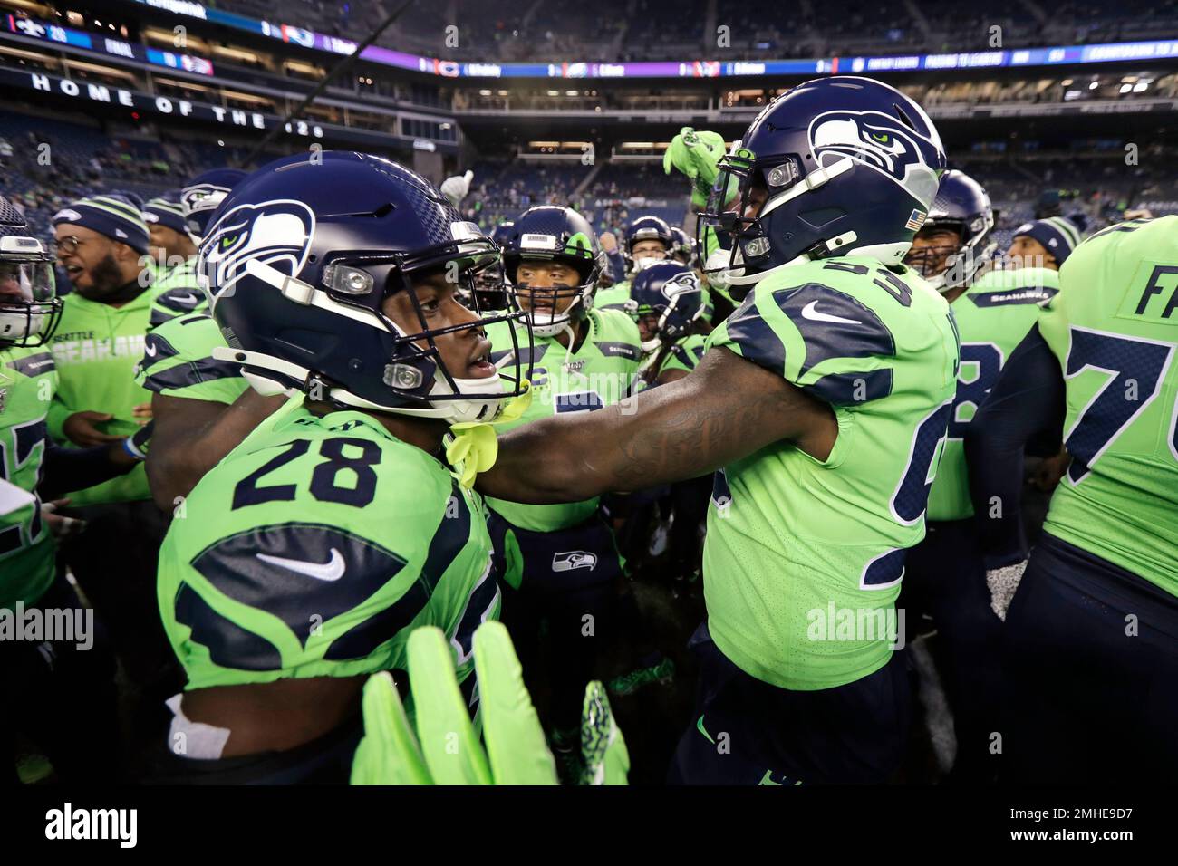 With quarterback Russell Wilson at the center, Seattle Seahawks huddle ...