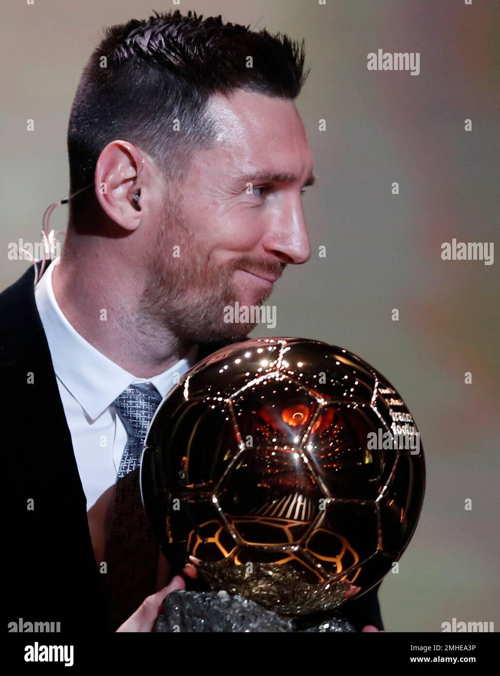 Barcelona's soccer player Lionel Messi holds the trophy of the Golden ...