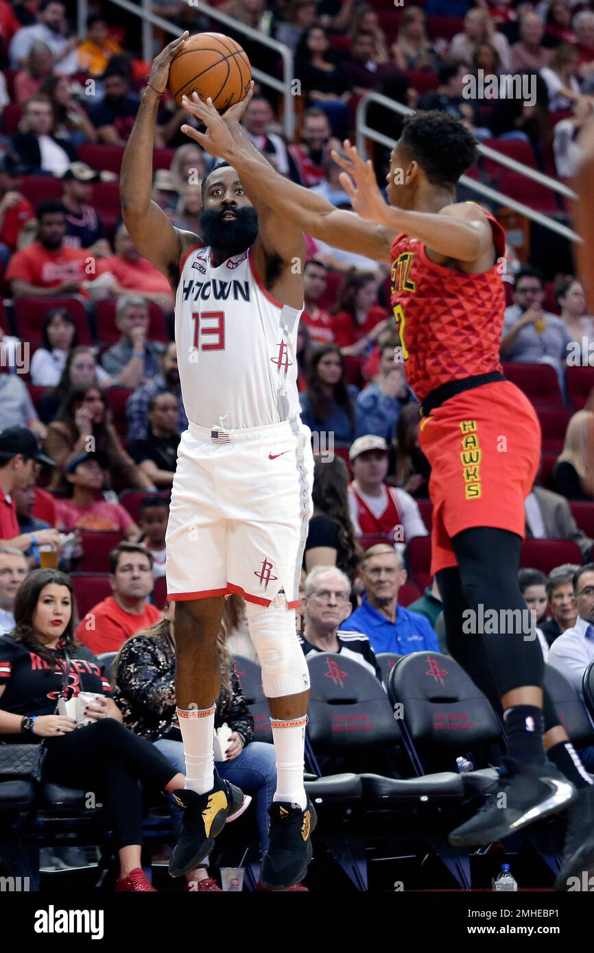 Houston Rockets guard James Harden (13) puts up a three point shot as ...