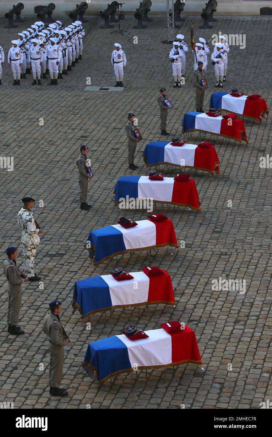 Soldiers stand by the coffins of seven of the 13 French soldiers killed ...