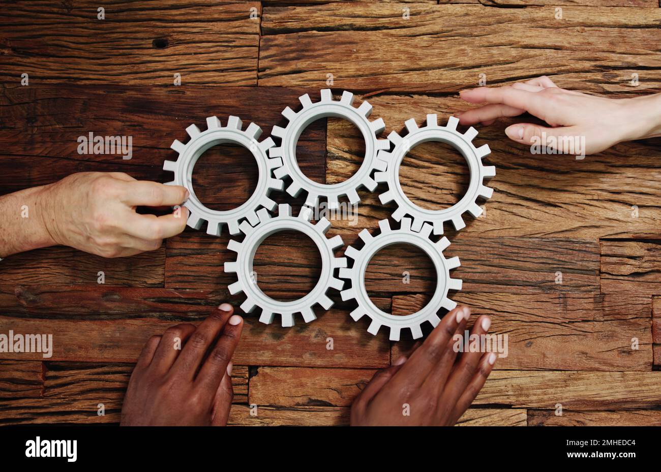 Hands Holding Interlocked Gear Wheels. Business Partnership Stock Photo ...