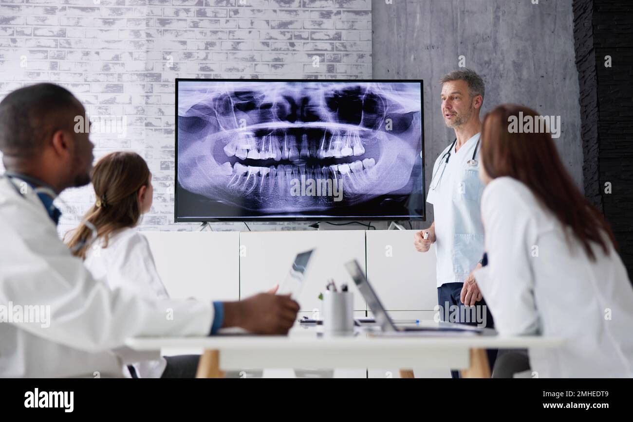 Dentist Doctors Looking At Teeth Xray Using Computer Software Stock ...