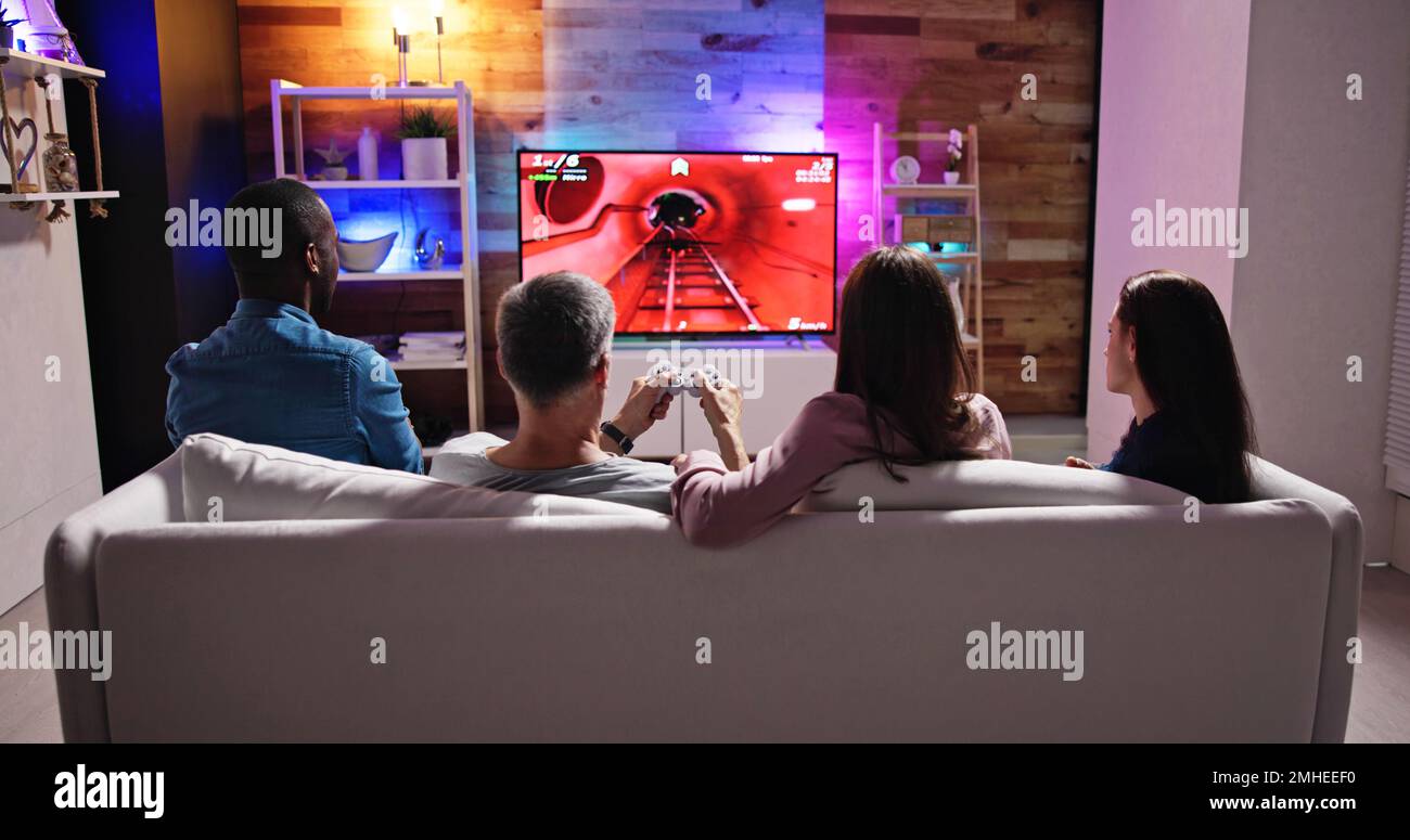 Rear View Of An People Playing Video Games At Home Stock Photo - Alamy